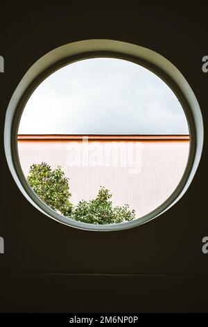 Round window tree and house Stock Photo - Alamy