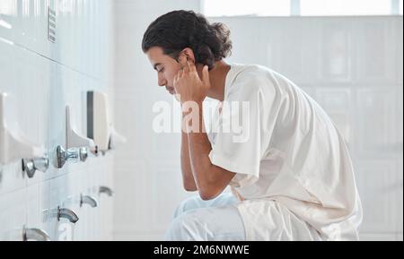 Islam, ablution and man washing before prayer in bathroom at mosque in ...
