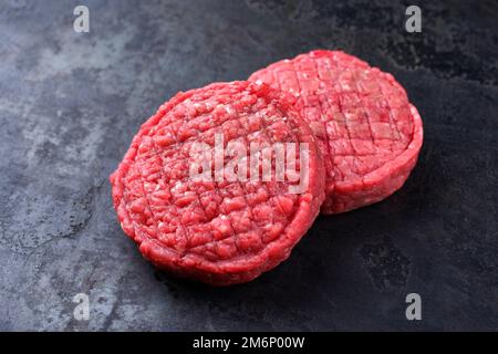 Raw barbecue beef Hamburger patty with herbs and spice offered as top ...