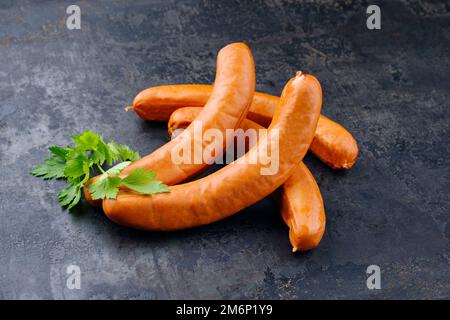 Traditional raw German bockwurst offered as top view on rustic black ...