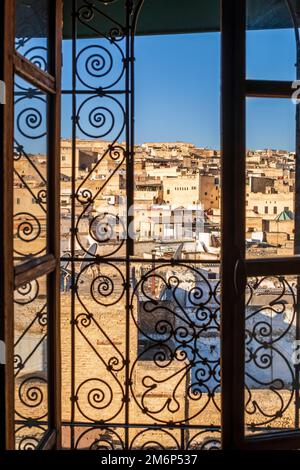 Fez medina seen through riad's window with decorative grate, Morocco ...