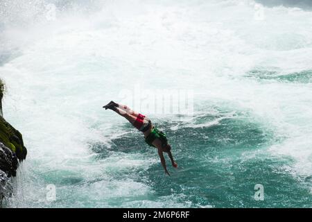 waterfall extreme brave man as superhero running jump and dive from the ...