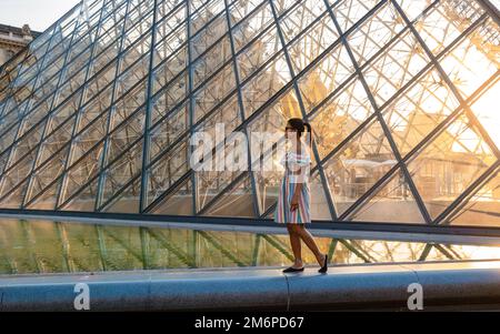 Louvre museum pyramid illuminated by sun rays at sunrise Stock Photo ...