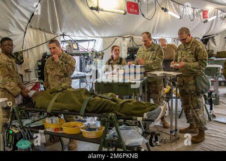 U.S. Army soldiers assigned to the 512th Field Hospital tending to a ...
