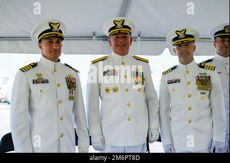 Rear Adm. Brendan McPherson (right) places the Coast Guard Cutter Pablo ...