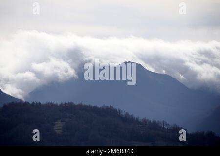 low clouds like fog in appennines valley around Bismantova stone a rock ...
