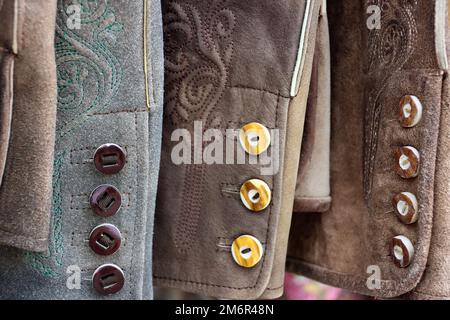 Traditional alpine leather pants with stag horn buttons Stock Photo - Alamy