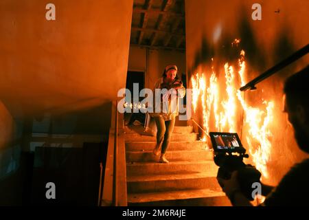Brave Fireman Descends Stairs of a Burning Building and Holds Saved ...