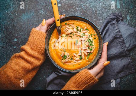 Female hands with bowl of pumpkin soup Stock Photo - Alamy