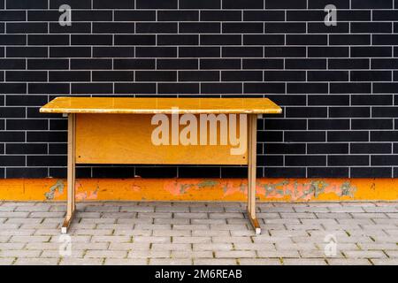 Old wooden school desk next the school building wall Stock Photo - Alamy