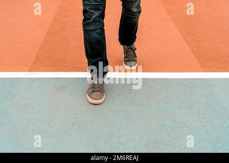 Man stepping over a white line Stock Photo - Alamy