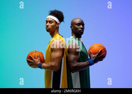 Image of portrait of two diverse basketball players facing each other ...