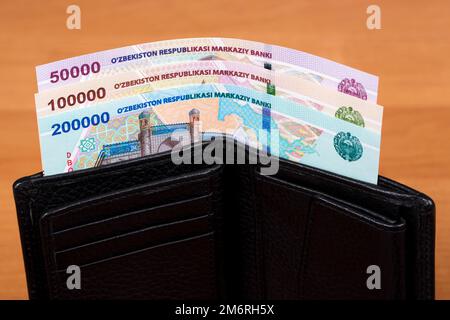Uzbekistani money in the black wallet Stock Photo - Alamy
