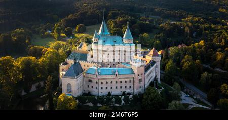 Aerial panorama view of Bojnice Castle in Slovakia surrounded by forest ...