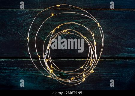 Fairy lights, led garland, overhead flat lay shot on a black background ...