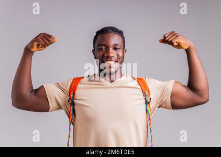 polyethnic man in beige t-shirt with an orange backpack holding book ...