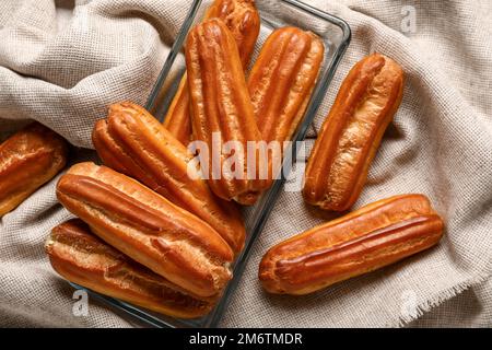 Glass bowl with sweet eclairs on fabric background Stock Photo - Alamy
