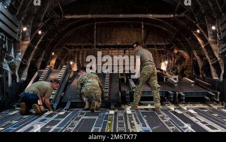 U.S. Airmen configure the ramp toes of a C-17 Globemaster III to ...