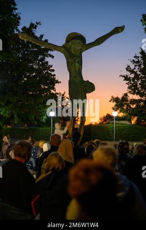 People venerating the statue of the Risen Christ in Medjugorje. The ...