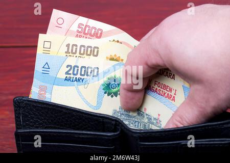 Madagascar money in a black wallet Stock Photo - Alamy