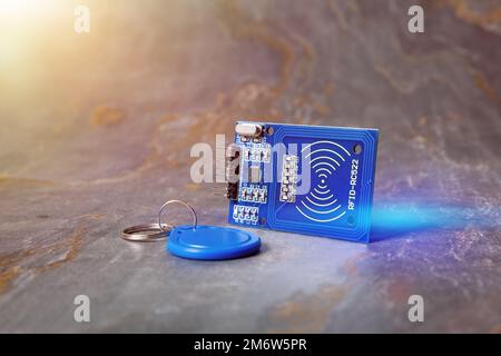 RFID chip sensor with its key tag and Pins for soldering on the board ...