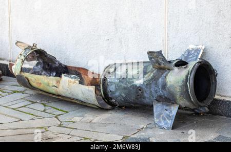 A metal fragment of a military rocket lies on the ground after the ...