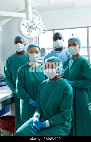 Diverse male and female surgeons ready for surgery in discussion in ...