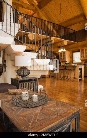 Bleached wooden stairs with black wrought iron railing, fireplace in ...
