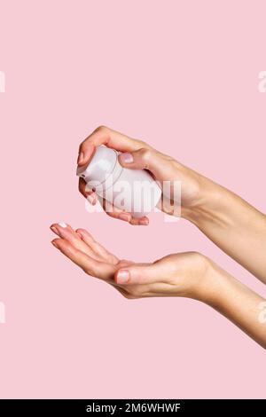Woman applying lotion to hand. Daily skincare and body care routine ...