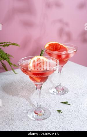 Grapefruit sparkling cocktails or lemonade garnish rosemary. View from ...