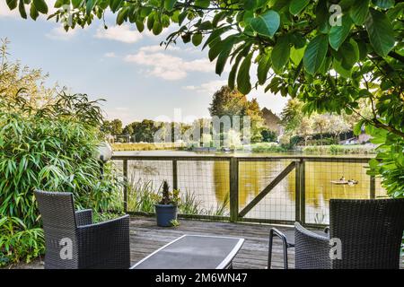 an outdoor patio area with wickers, chairs and table in the foreground ...