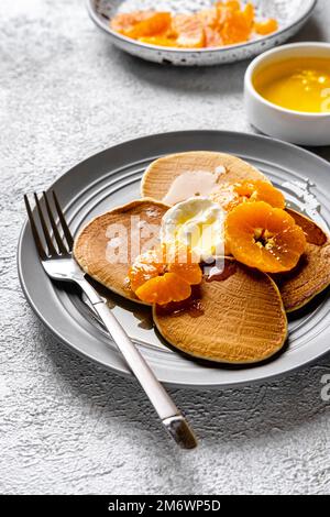 Delicious pancakes with tangerines and honey or maple syrup for ...