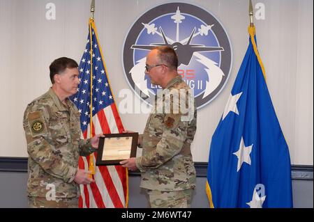 Air Force Col. Robert Lyons (center), salutes Air Force Lt. Gen. Eric ...