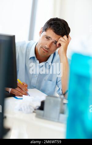Tired man trying to meet deadline in office Stock Photo - Alamy