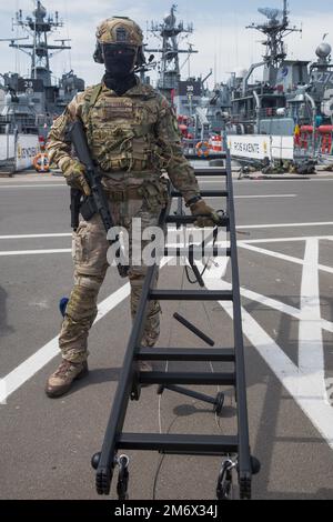 A member of the Romanian Naval Special Operations Forces demonstrates ...