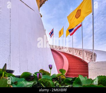 Dharmachakra flags and National Thai flag at sunset in Bangkok, Golden ...
