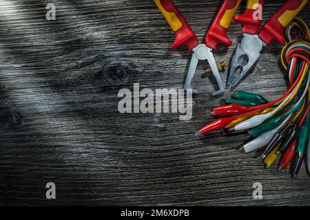 Electric wires pliers insulation wire cutter nippers on wooden board ...