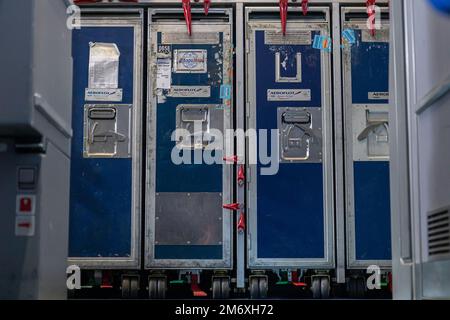 Food carts with meals for passengers on the plane. Storage space on the ...