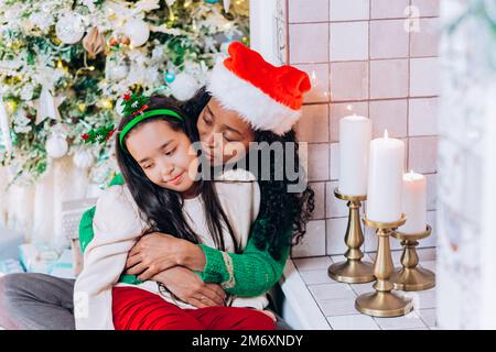 African American woman in santa claus hat on orange background, Happy ...