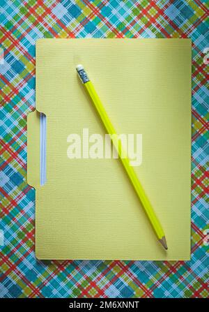Manila file folder on checked background Stock Photo - Alamy