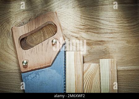 Hacksaw timber on wood board top view construction concept Stock Photo ...