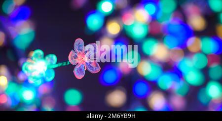 Multicolored lights bokeh from decorative luminous flowers garlands at ...