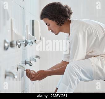 Islam, ablution and man washing before prayer in bathroom at mosque in ...