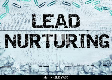 Hand writing sign Lead Nurturing, Business approach method of building ...