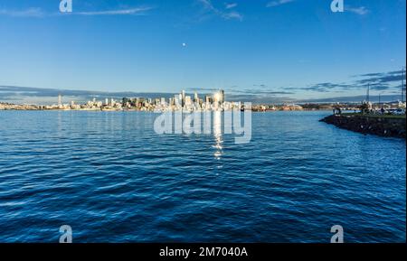 The sun reflects from buildings in the skyline of Seattle, Washington ...