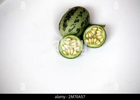 Prickly paddy melon (Cucumis myriocarpus) a small green fruit with dark ...