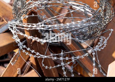 Barbed wire stretched over anti-tank hedgehogs. Fortified defense line ...