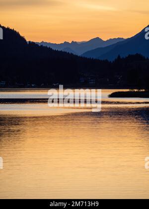 Evening atmosphere at sunset at Lake Weissensee, highest bathing lake ...