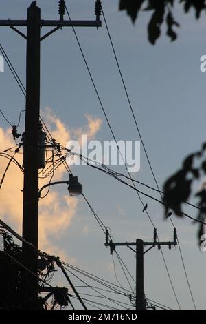 Telephone poles and cables during sunrise Stock Photo - Alamy
