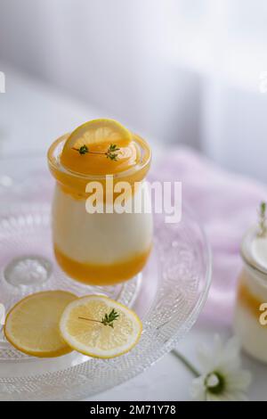 Lemon curd and greek yogurt with thyme in glass jars. Soft romantic ...